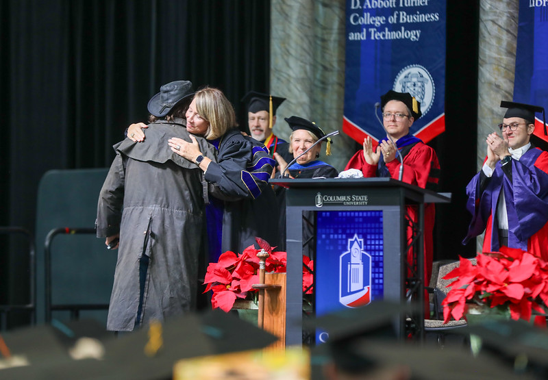 Rayfield hugging Ressmeyer at the conclusion of one of his speeches