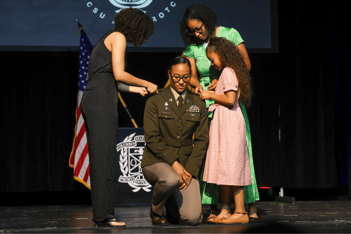 ROTC cadet being pinned with 2LT bars by family members