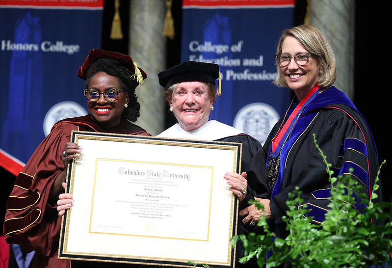 Ann Strub (center) receives an honorary degree from President Rayfield ...